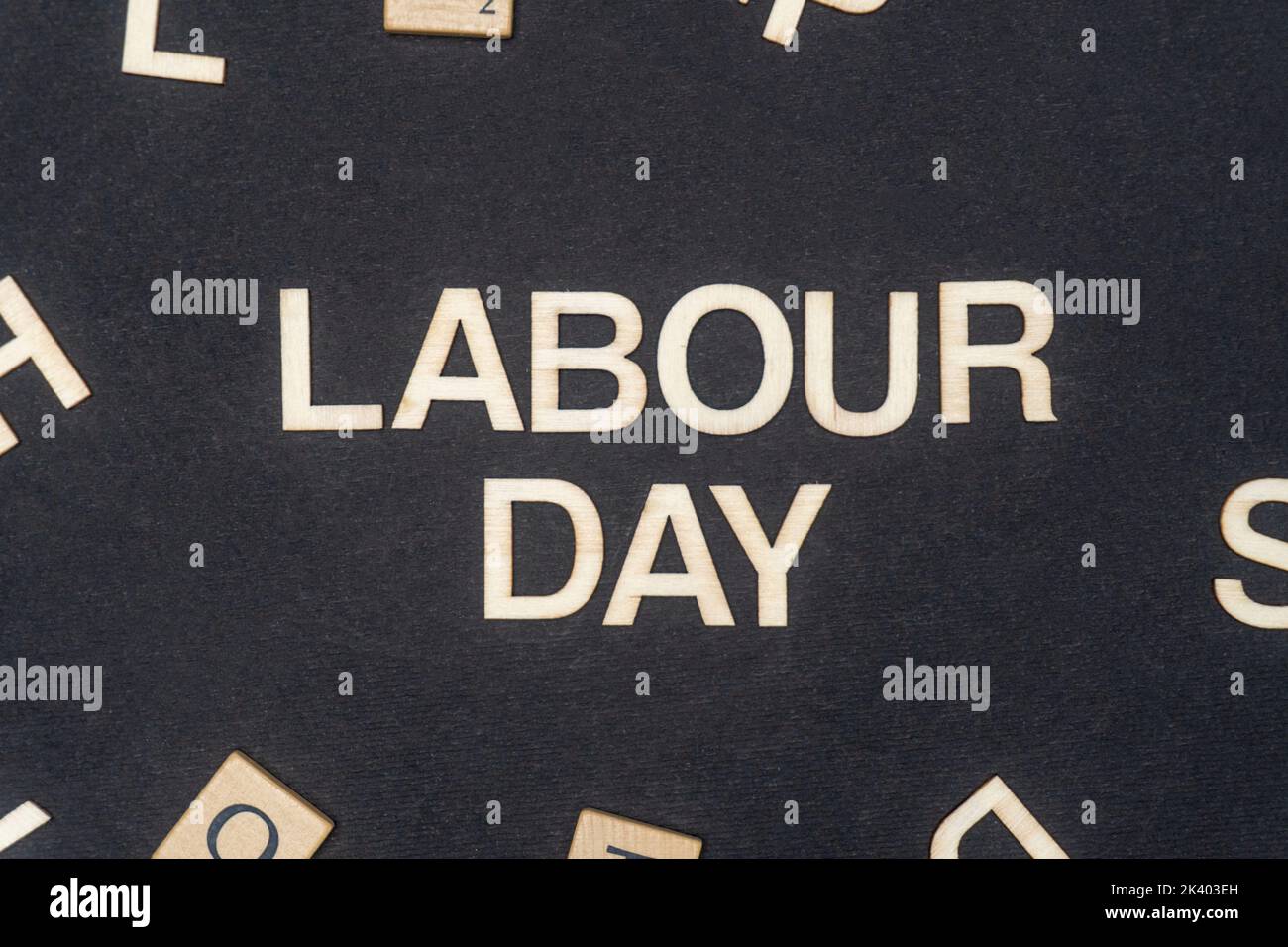 LABOUR DAY word written on dark paper background. LABOUR DAY text on ...