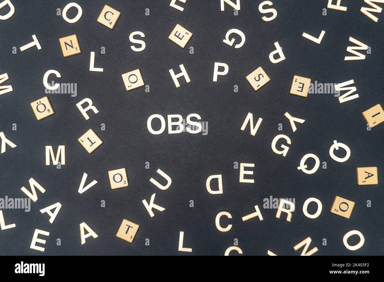 OBS word written on dark paper background. OBS text on dark for your ...