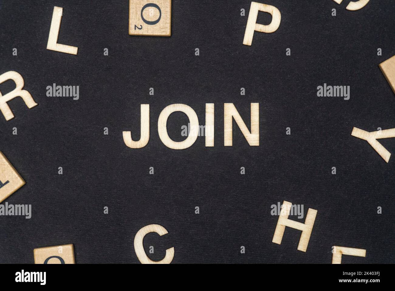 JOIN word written on dark paper background. JOIN text on dark for your ...