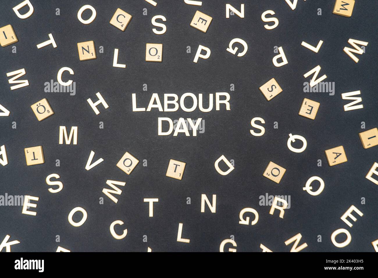 LABOUR DAY word written on dark paper background. LABOUR DAY text on ...