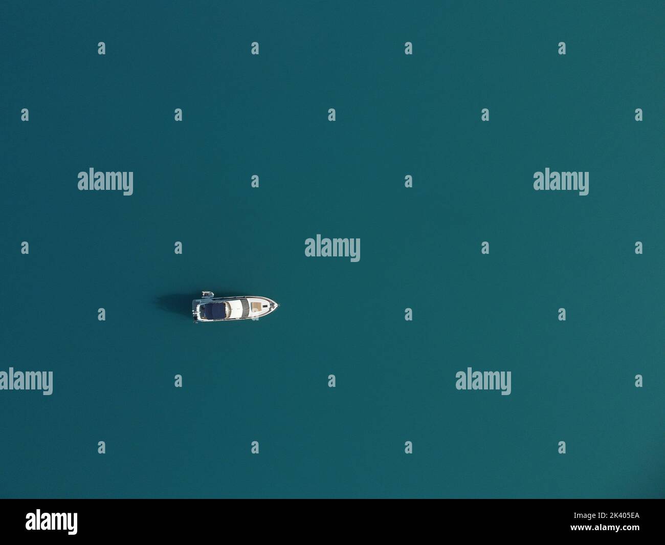 Aerial yacht on calm sea. Luxury cruise trip. View from above of white ...