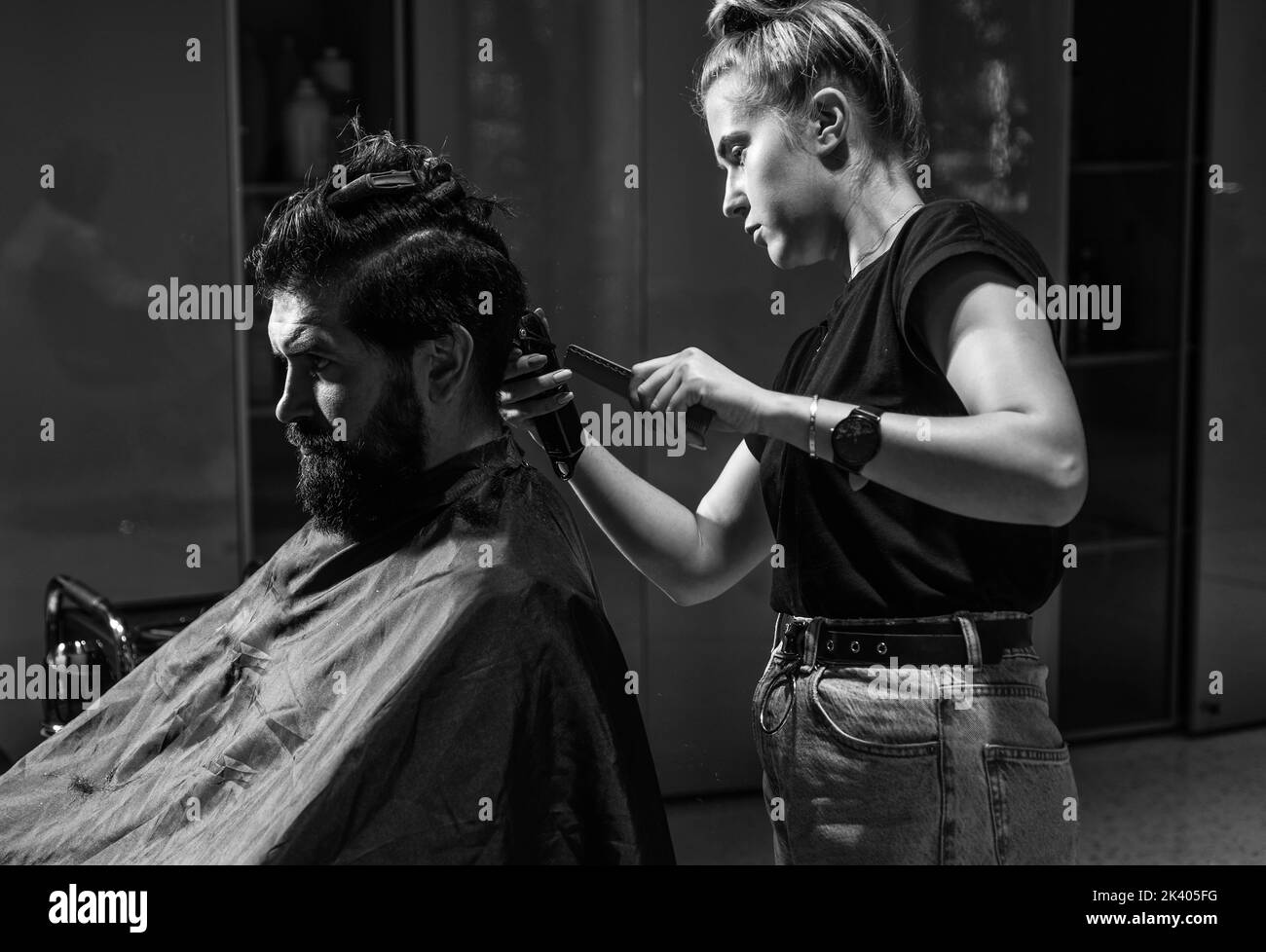 shot of hairdresser cutting hair of handsome man client, Hairstylist ...