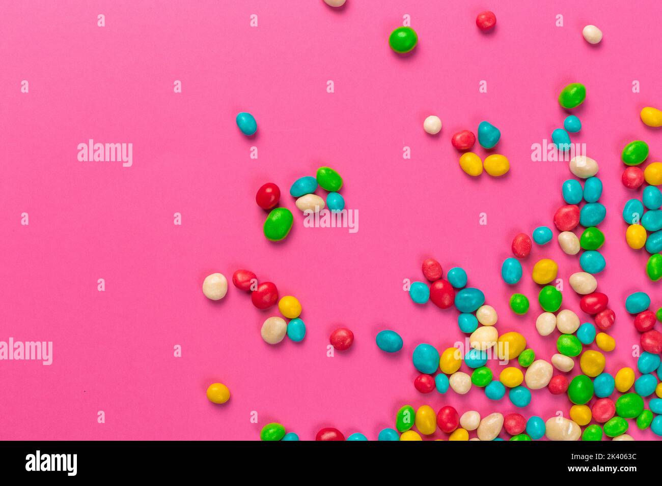Colorful lollipops on a pink background Stock Photo - Alamy