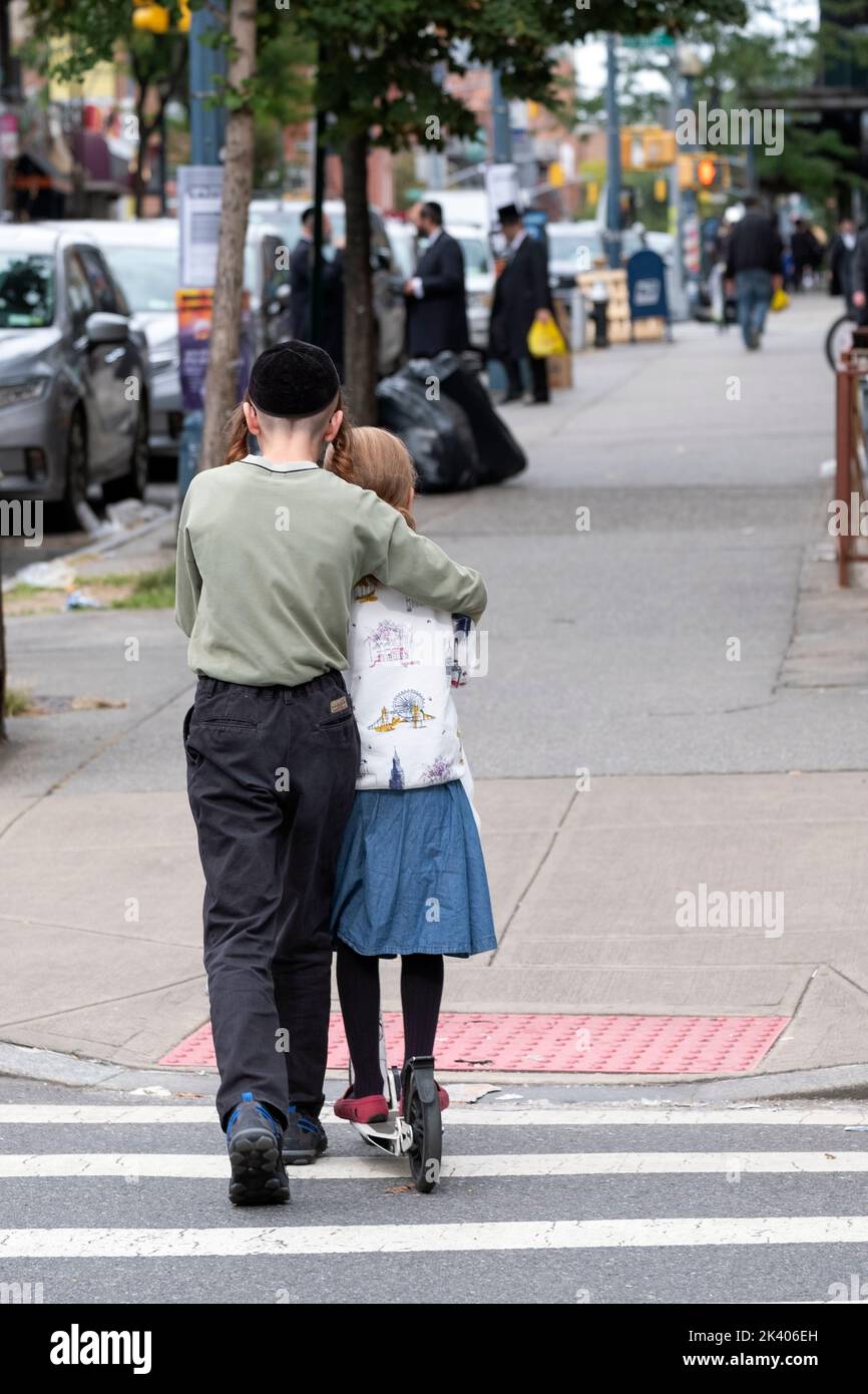 An anonymous Hasidic Jewish teenager teaches his sister how to ride a ...