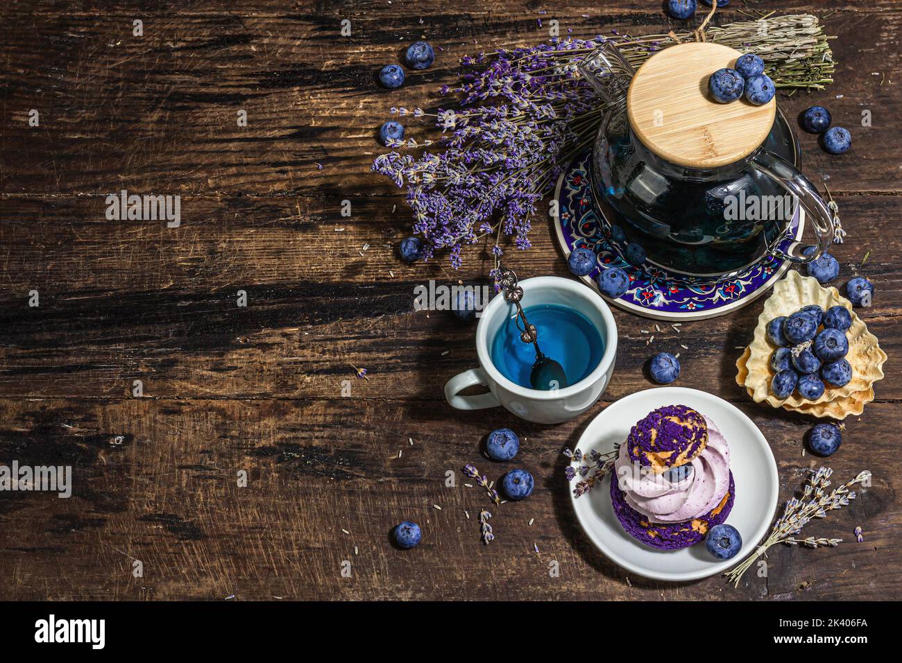 The concept of romantic tea. French Shu cake, Lavender tea, blueberries ...