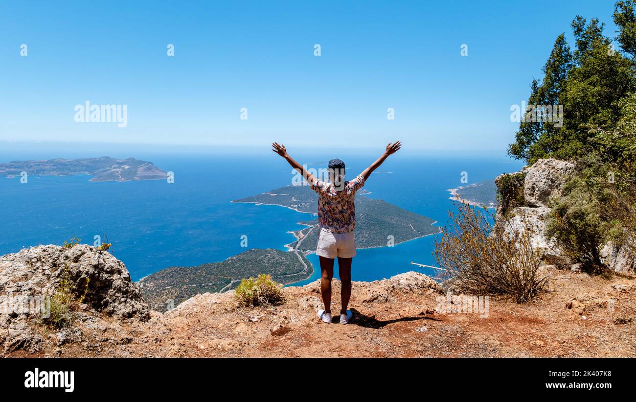 Kas turkey Asian women hiking up the mountain looking out over the ...