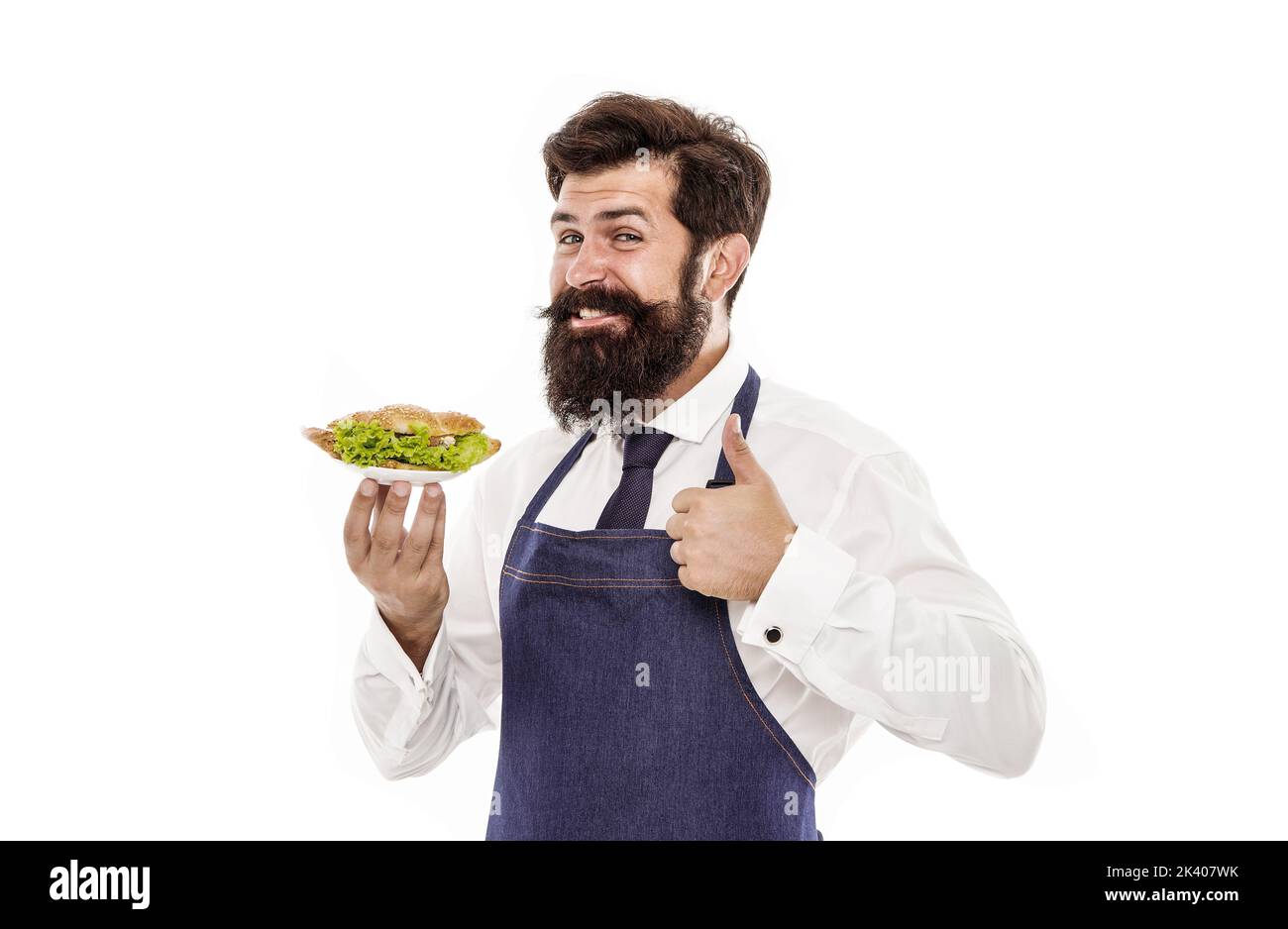 Cafe concept. Guy serving croissant stuffed with lettuce and fresh ...