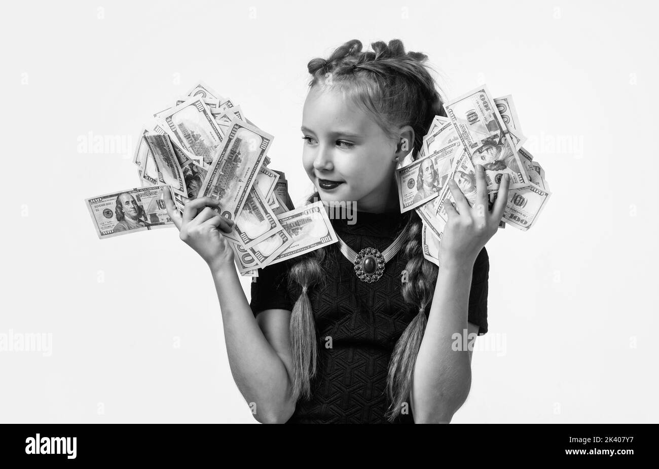 pretty teen girl with pigtails has lots of money isolated on white ...
