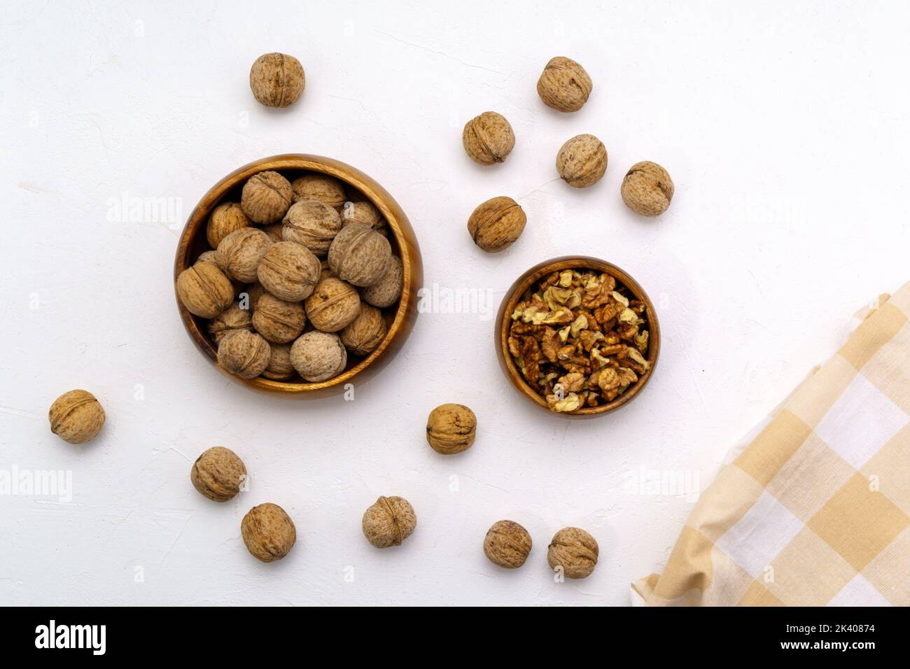 Walnuts in a wooden bowl on a white background with a copy space. View ...