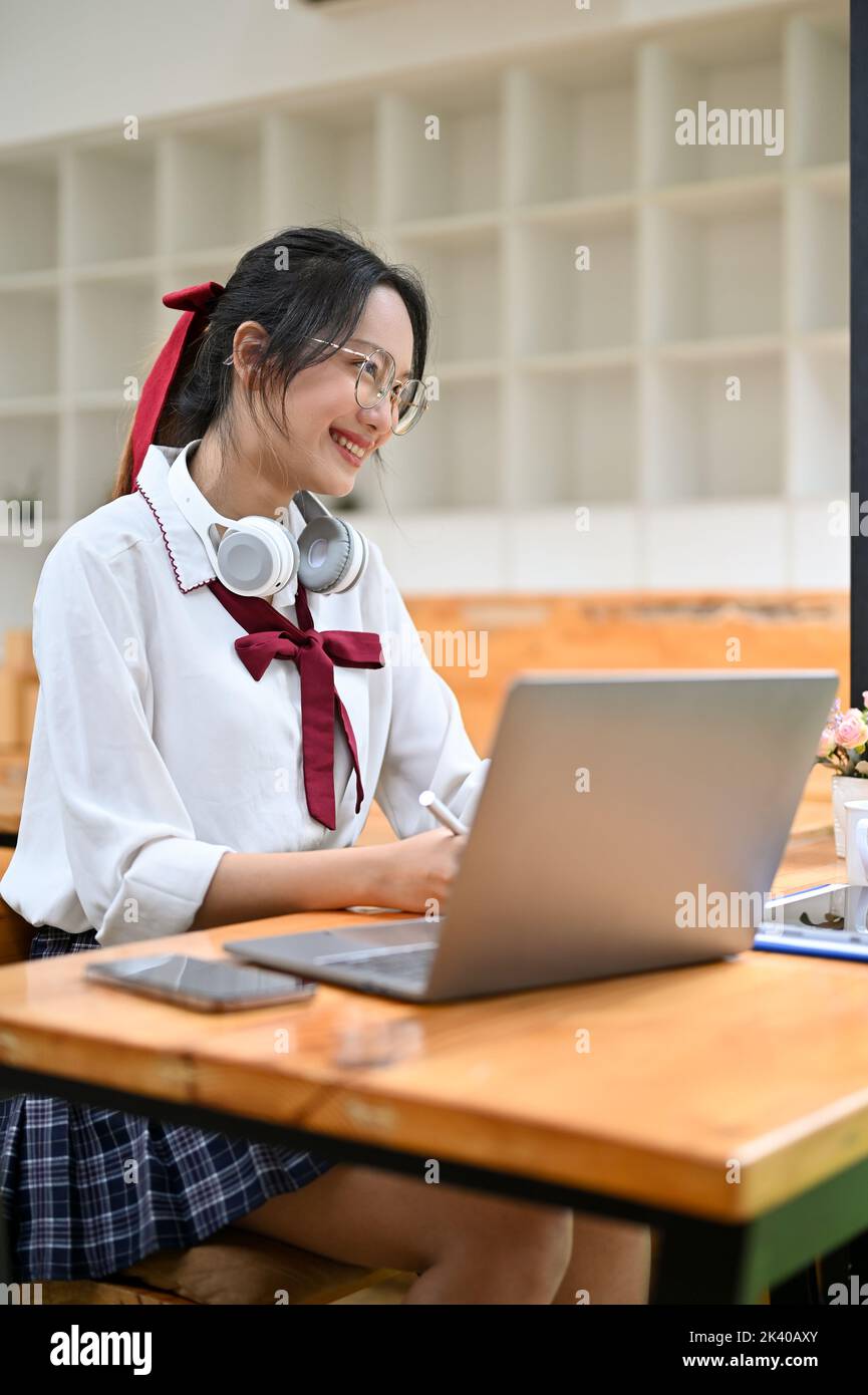 Portrait, Charming young Asian female high school student in uniform ...