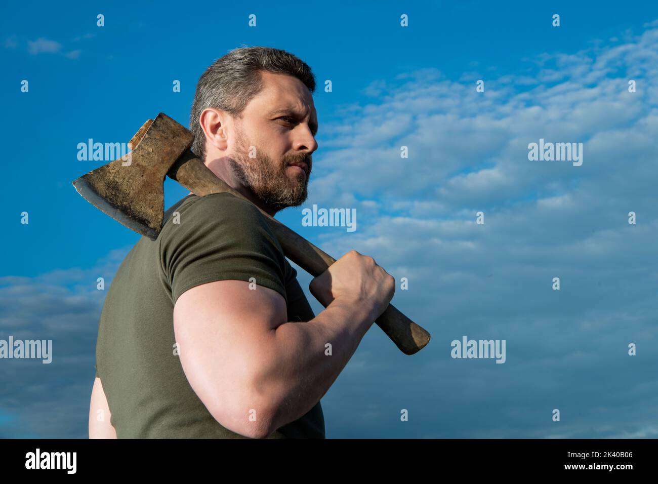 man with axe. lumberjack man hold ax. brutal man on sky background ...