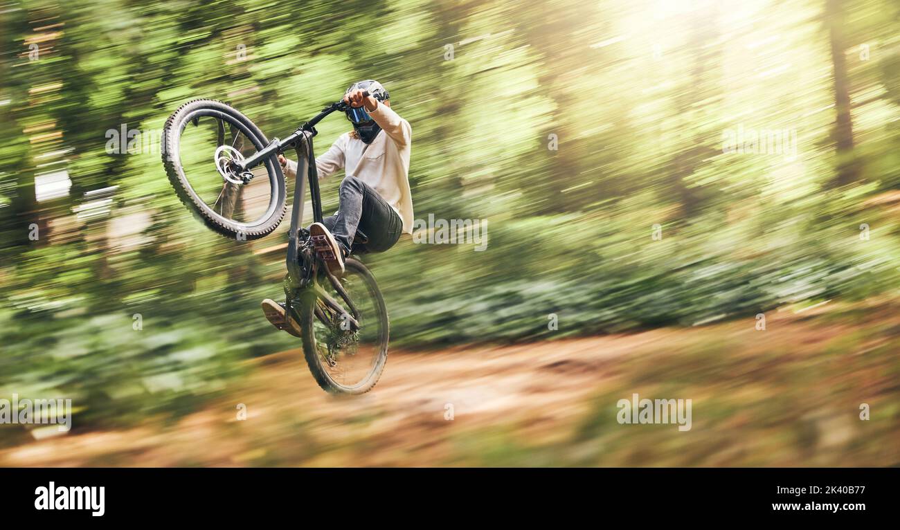 Motion blur of mountain bike man, action jump and bicycle speed ...