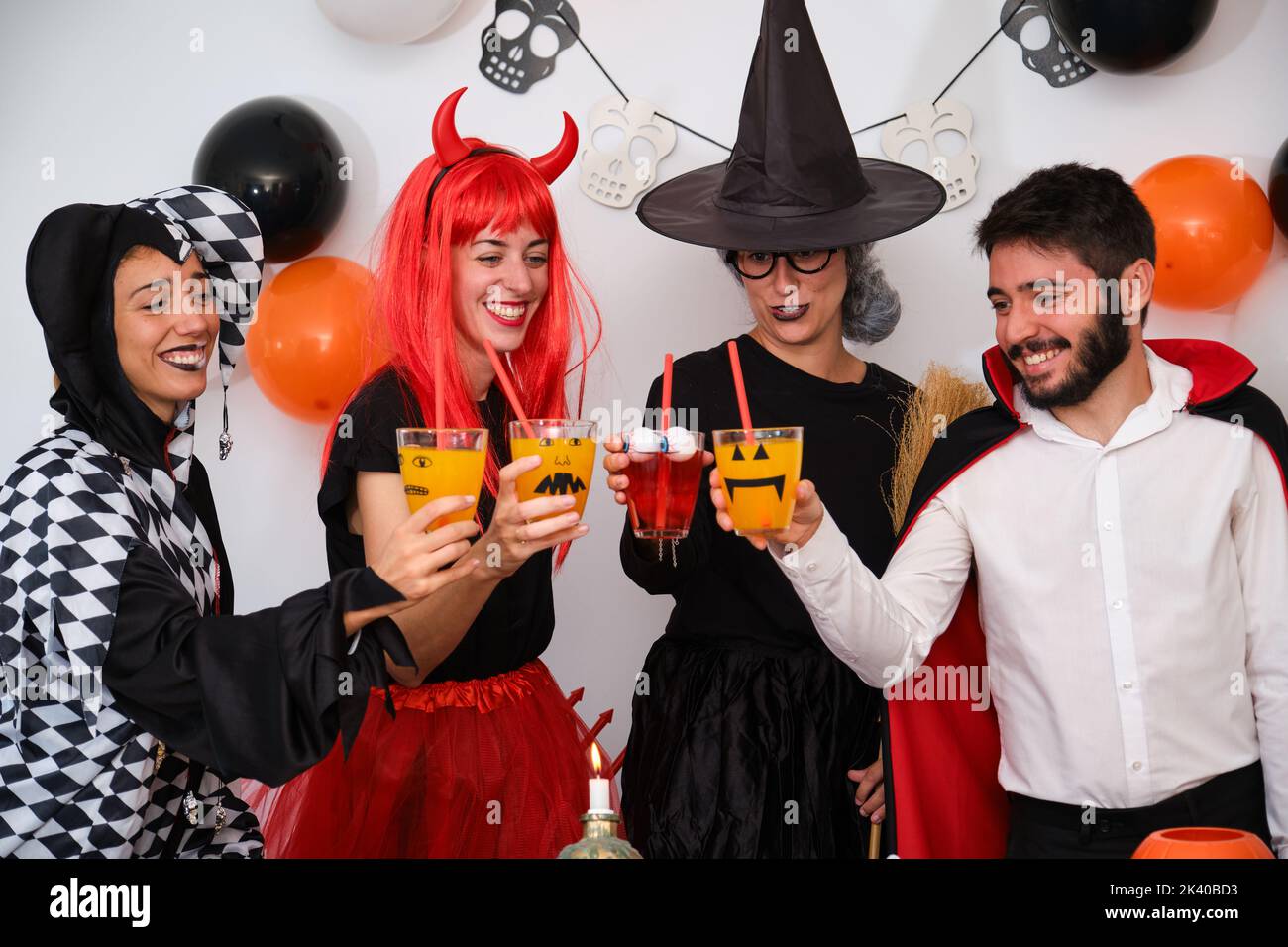 Four people doing a toast at a costume Halloween party Stock Photo - Alamy