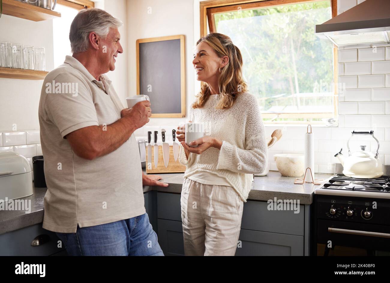 Relax Coffee And Elderly Couple Bonding In A Kitchen Talking And