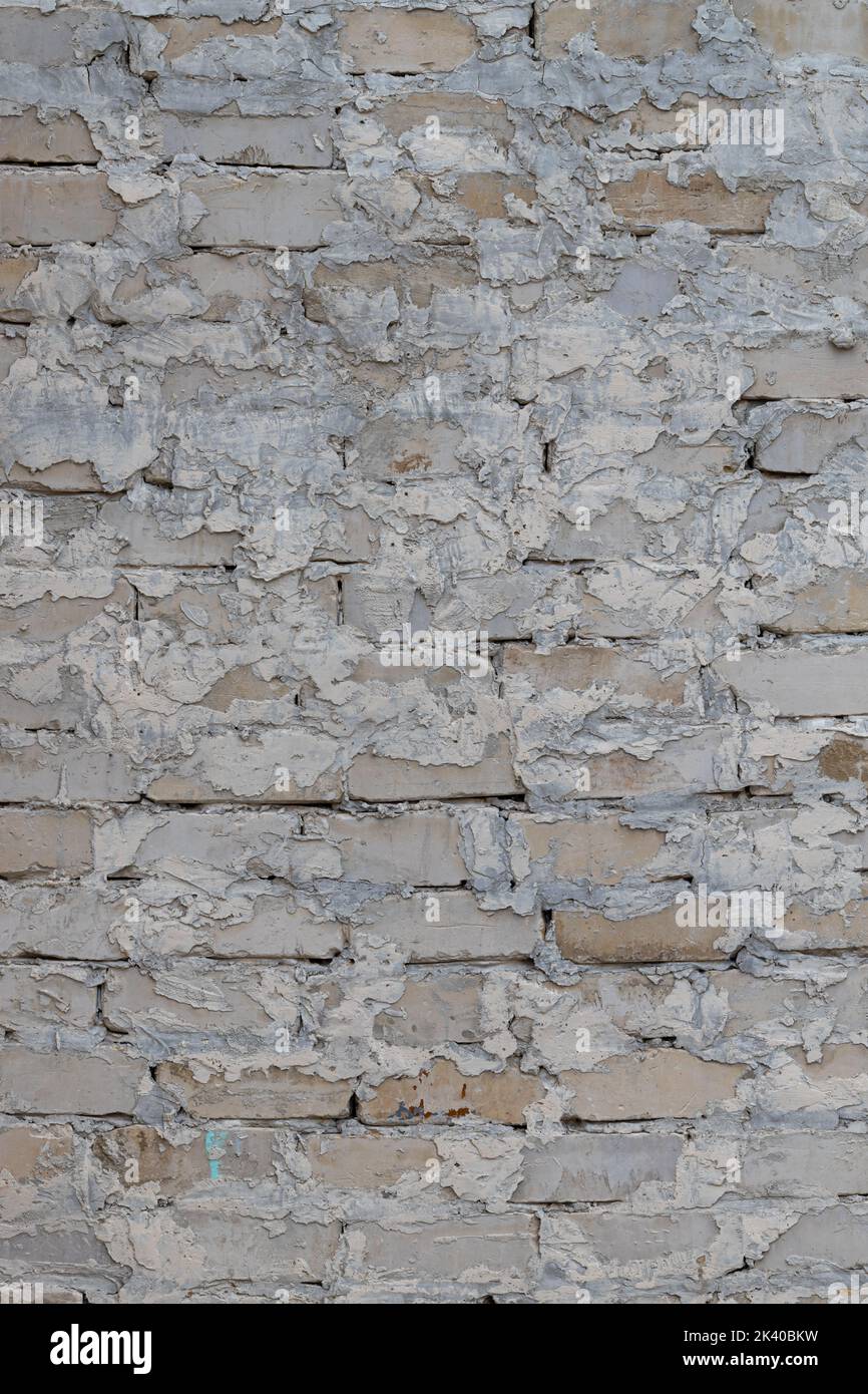 background brick wall covered with a layer of plaster. layer of plaster ...
