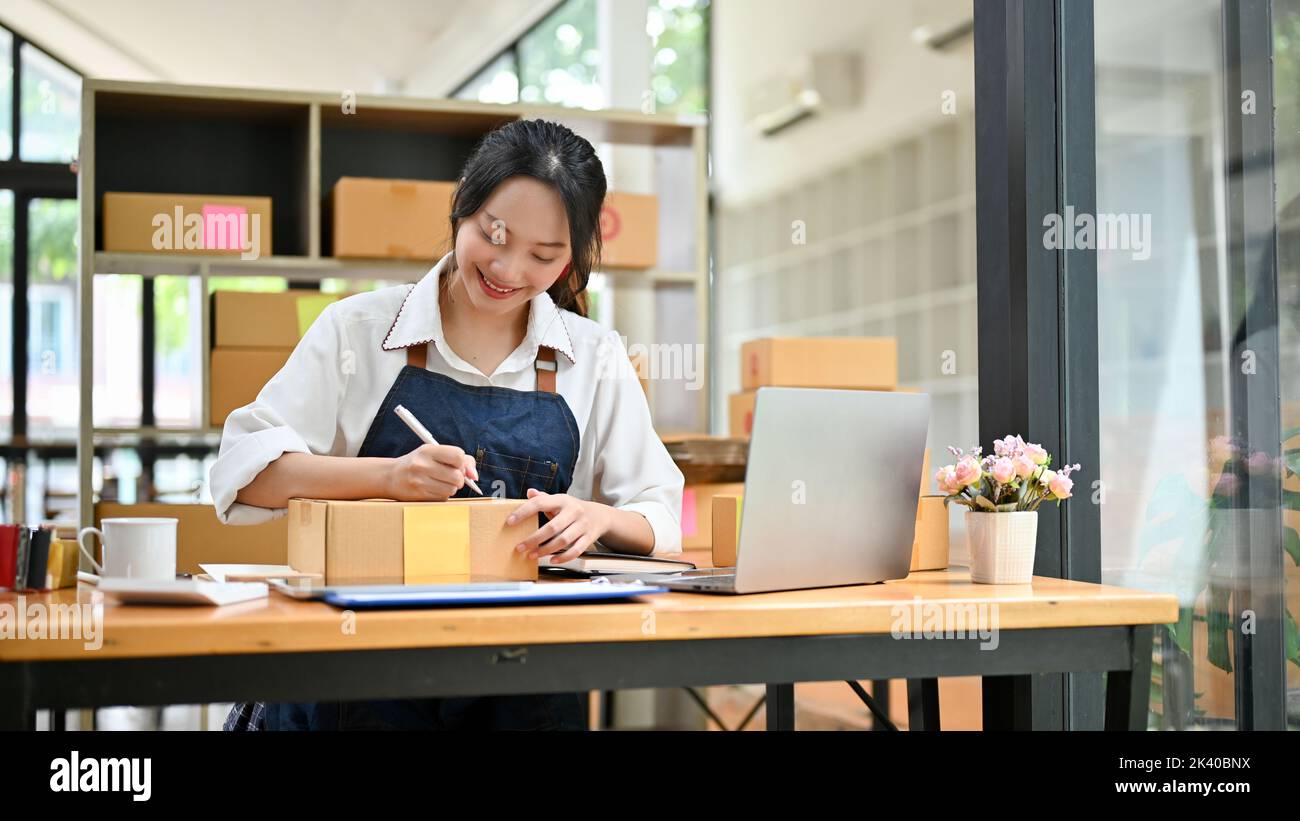 Attractive young Asian female worker or small online business owner ...