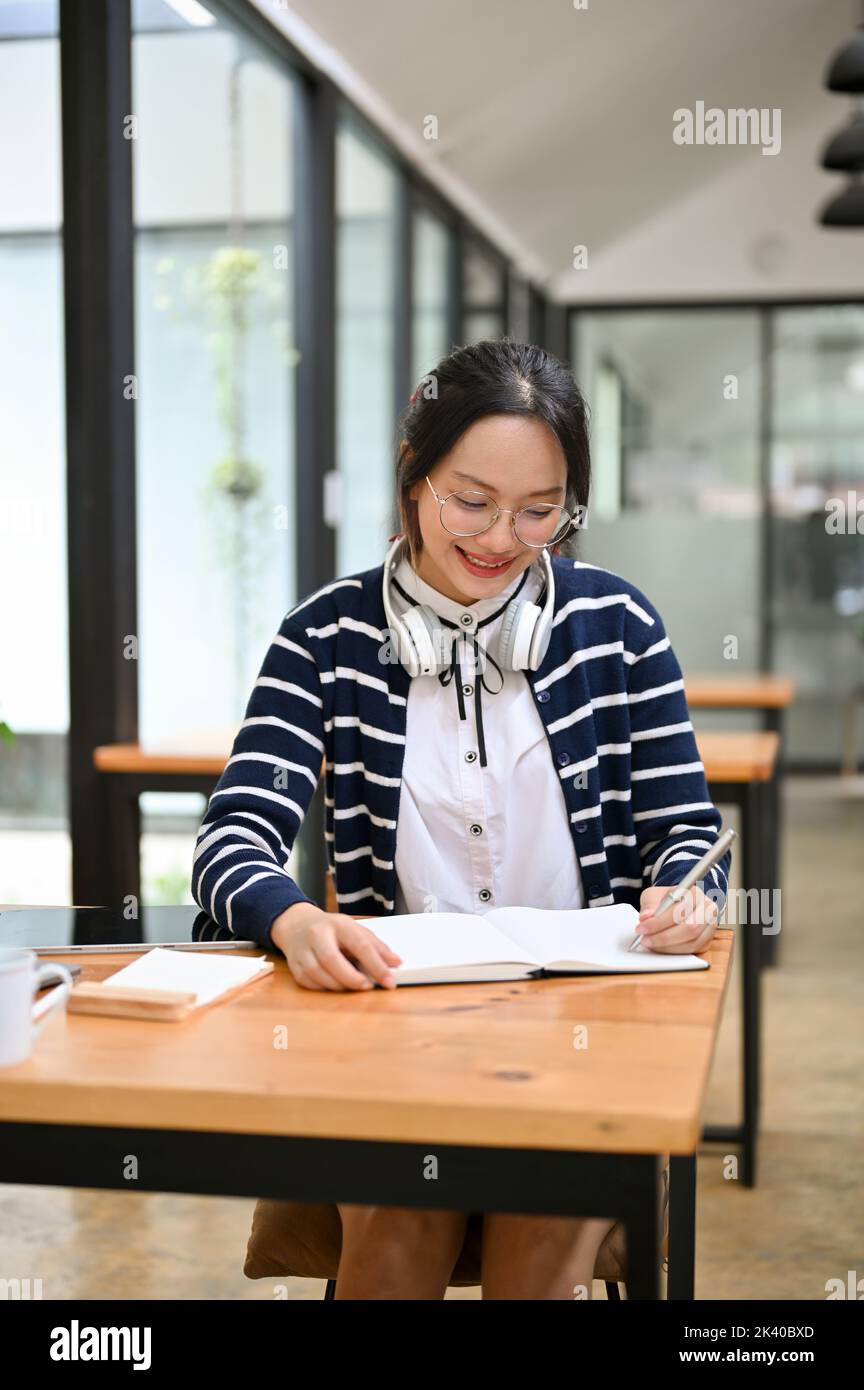 Portrait, Smart and charming young Asian female college student doing ...