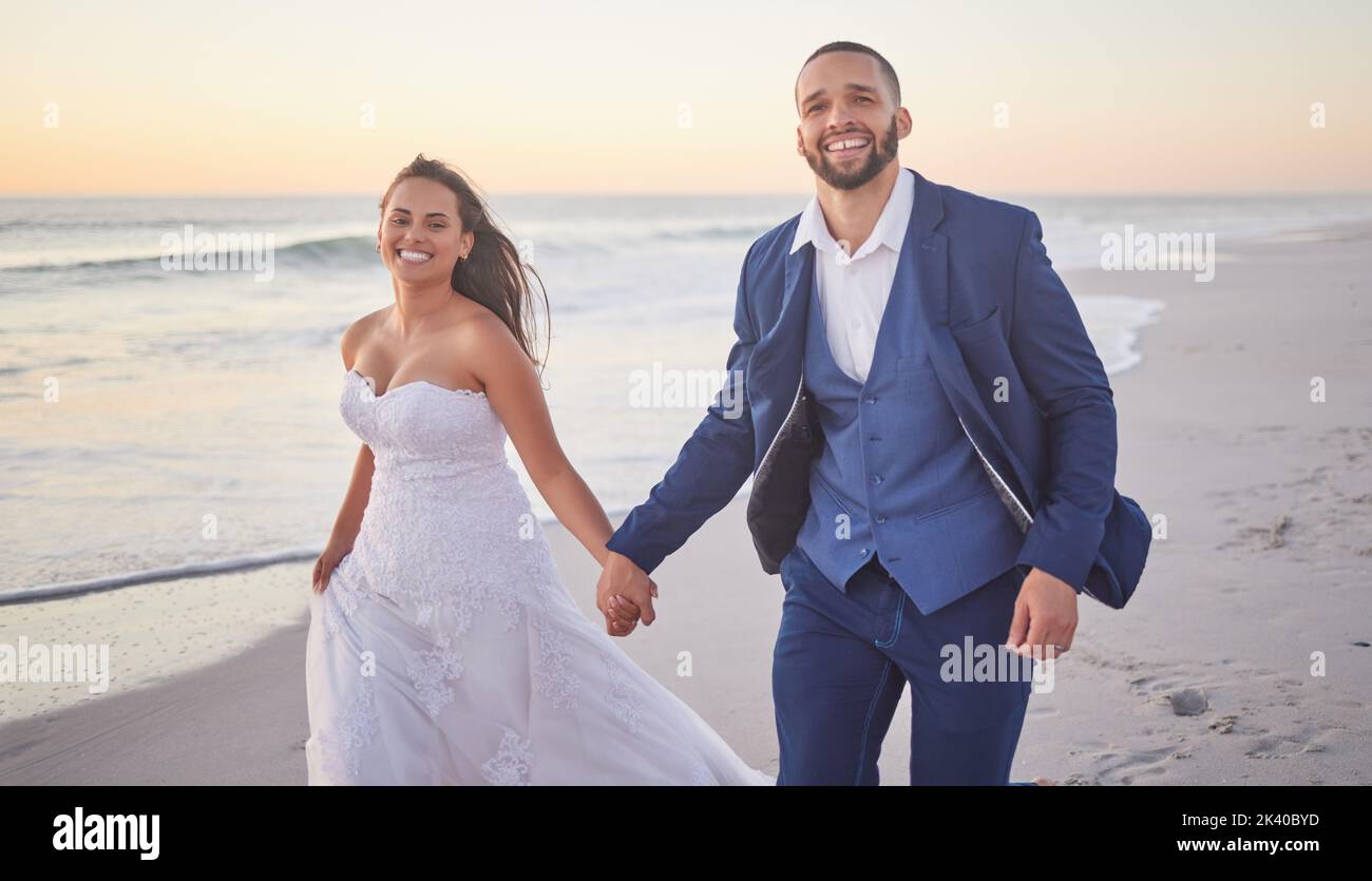 Bride, groom and couple celebrate wedding on the beach during sunset on ...