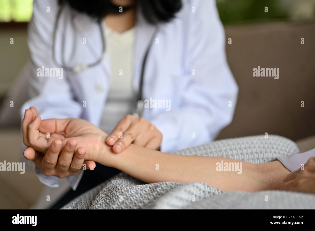 Cropped shot, Professional Asian female doctor checking pulse of her ...
