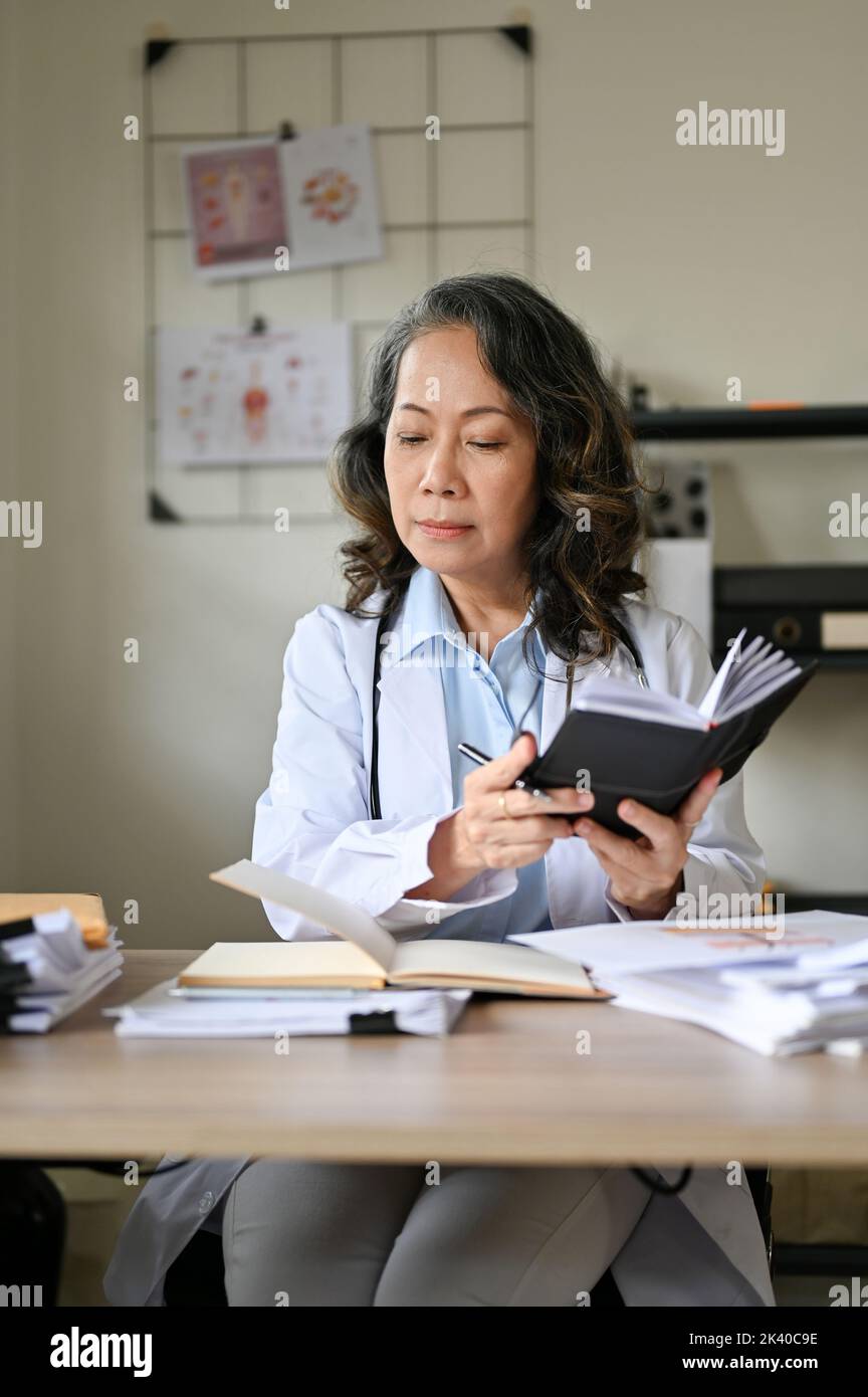 Portrait, Professional and smart senior Asian female doctor or ...