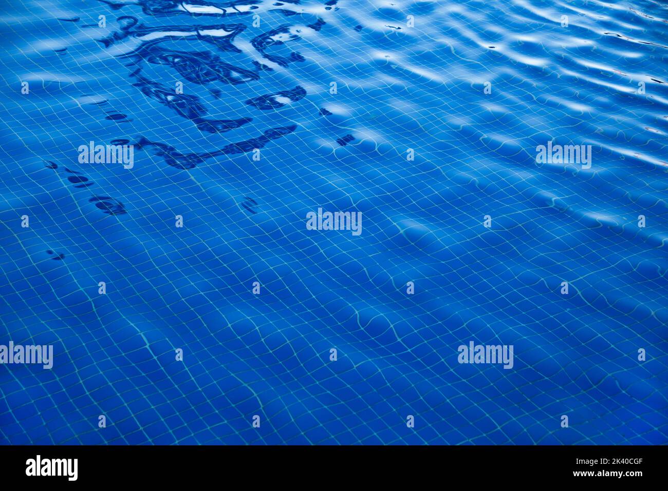 Bottom of the swimming pool with blue water Stock Photo - Alamy