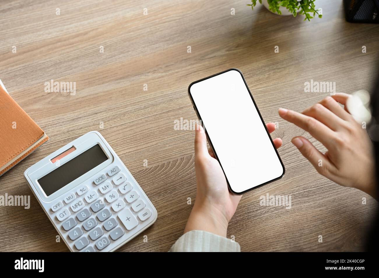 Above view, A female accountant or businesswoman using her smartphone ...
