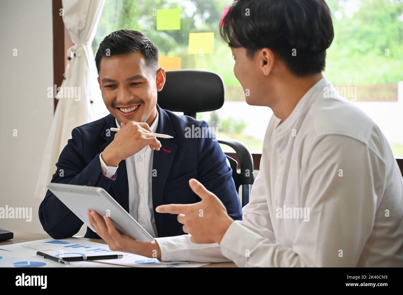 Smart young Asian male financial consultant having a meeting with his ...