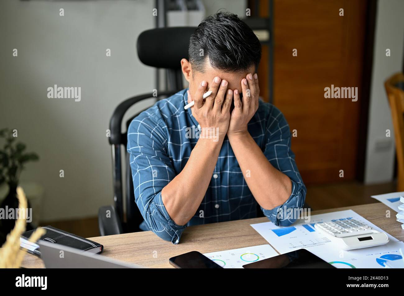 Stressed Asian businessman or male business startup entrepreneur ...