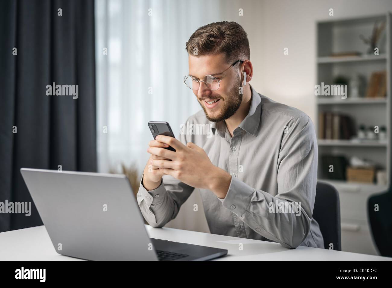 Happy smiling handsome man use smartphone for texting, student use app ...