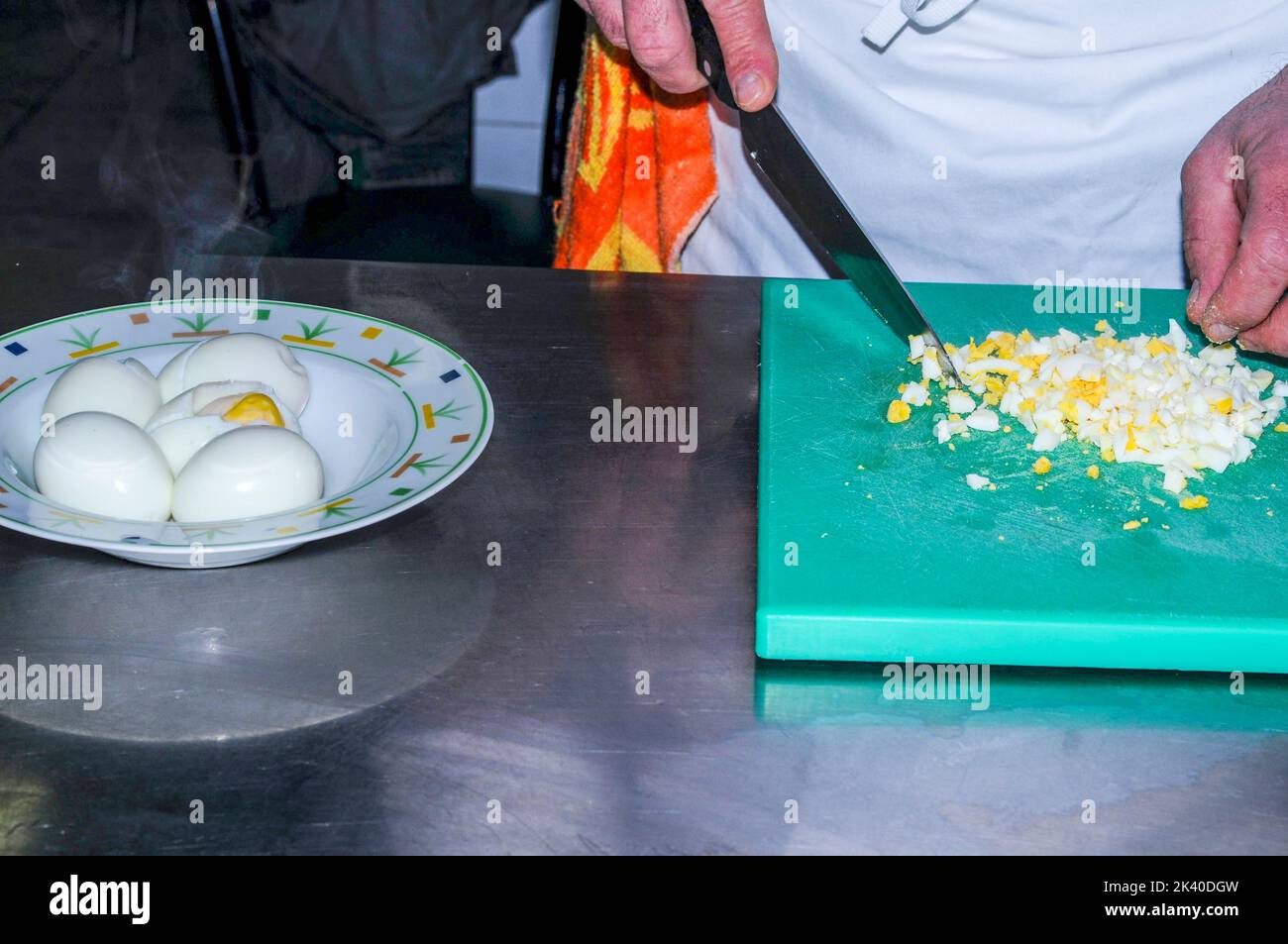 Chef chopping hard boiled eggs, to make a meal Stock Photo - Alamy
