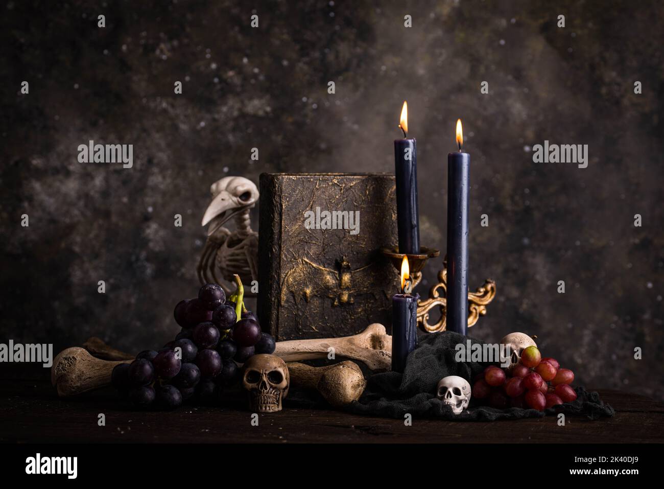 Halloween still life with skull, bones and cake Stock Photo - Alamy