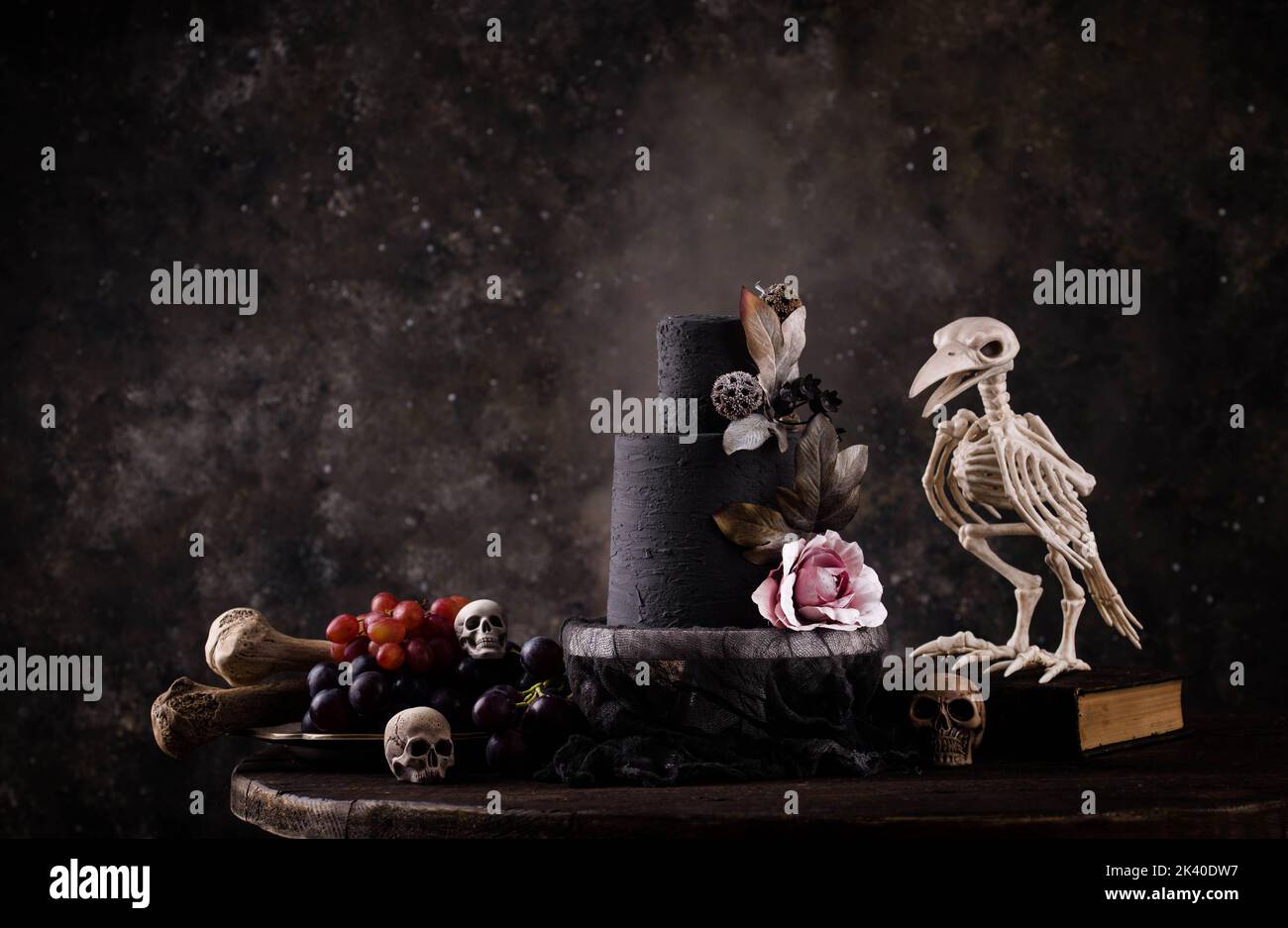 Halloween still life with skull, bones and cake Stock Photo - Alamy