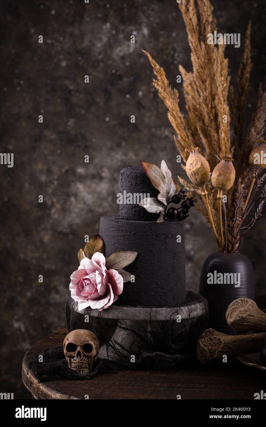 Halloween still life with skull, bones and cake Stock Photo - Alamy