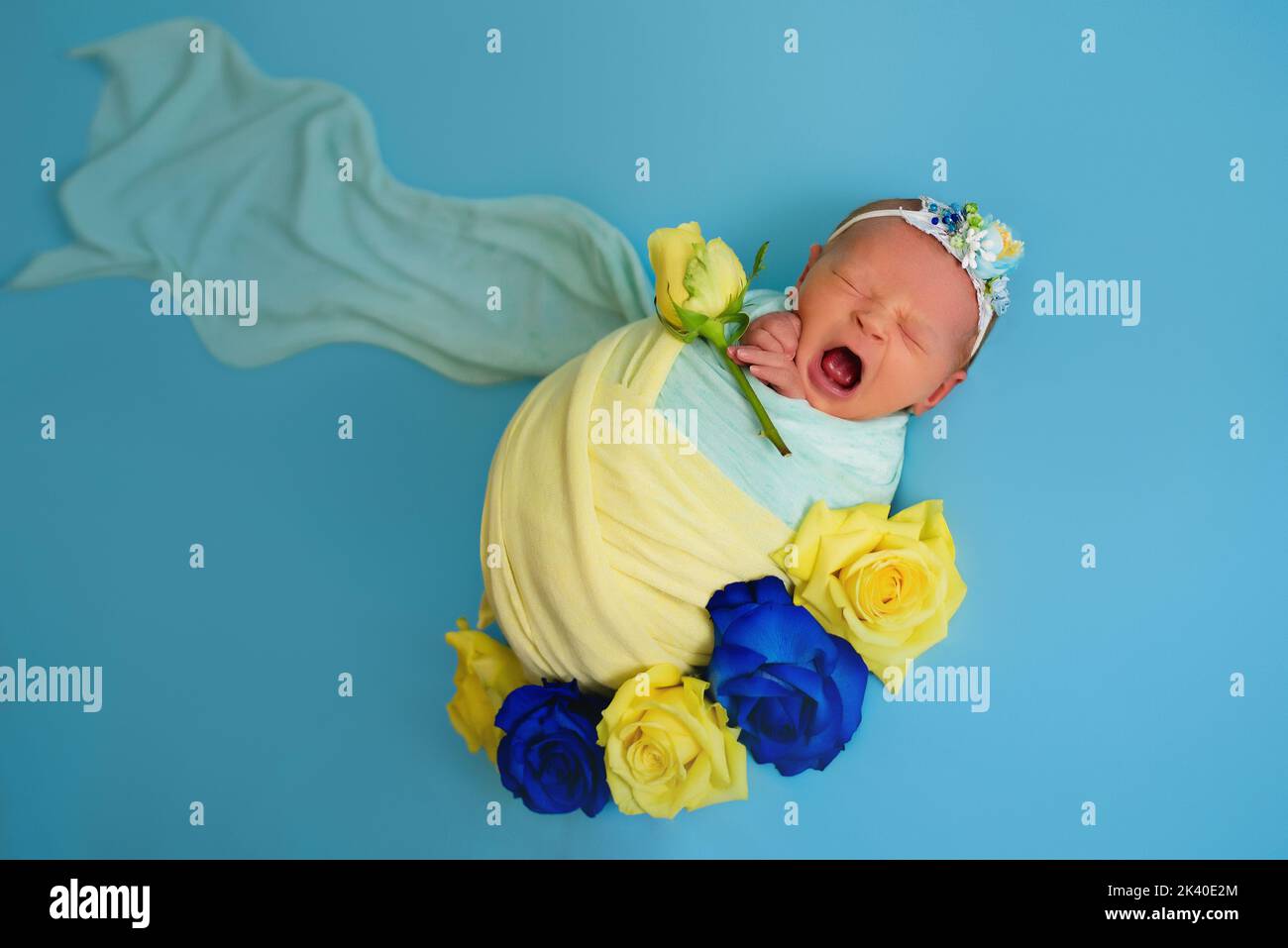 Ukrainian newborn crying in the studio patriotic blue yellow colors ...