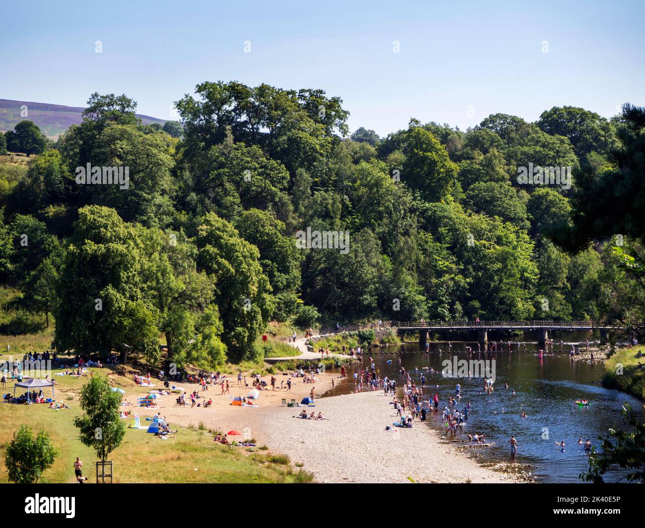 People on the beach by the River Wharfe on a hot day in summer 2022 at ...