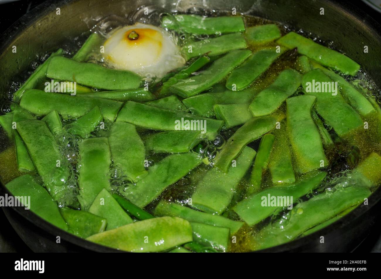 Green beans cooking in a pot in the kitchen Stock Photo - Alamy