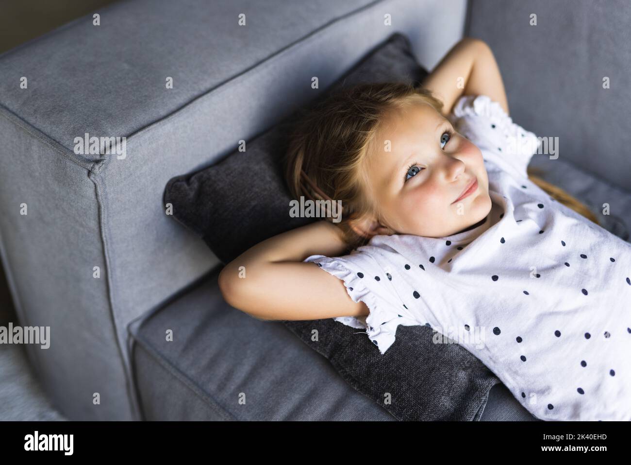 little cute girl sleeping on sofa after study in school daytime Stock ...