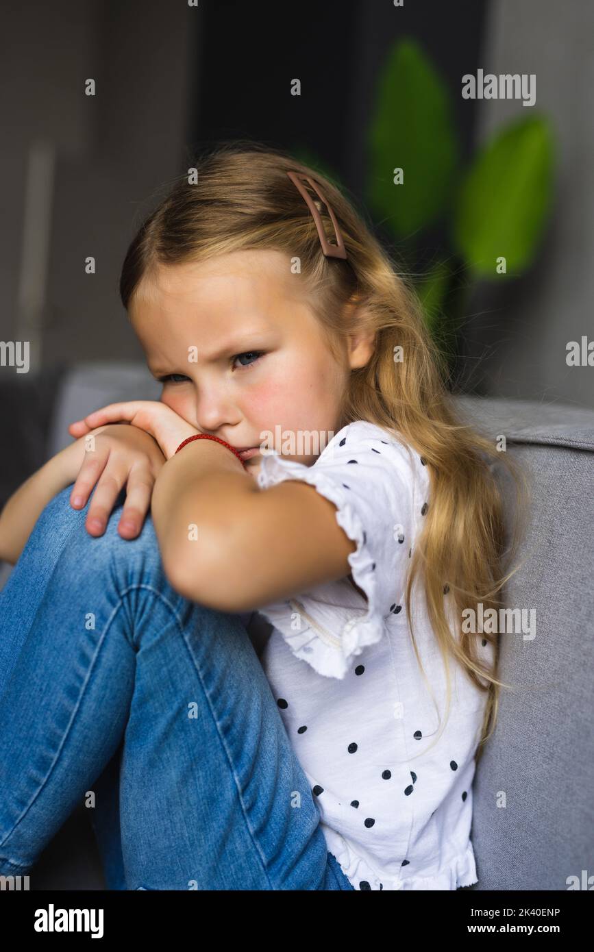 Depressed young girl hugging her knees and feeling like crying alone at ...