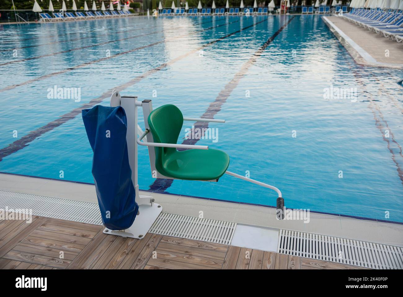 Swinging arm disabled chair. Swimming pool lift with a chair Stock ...