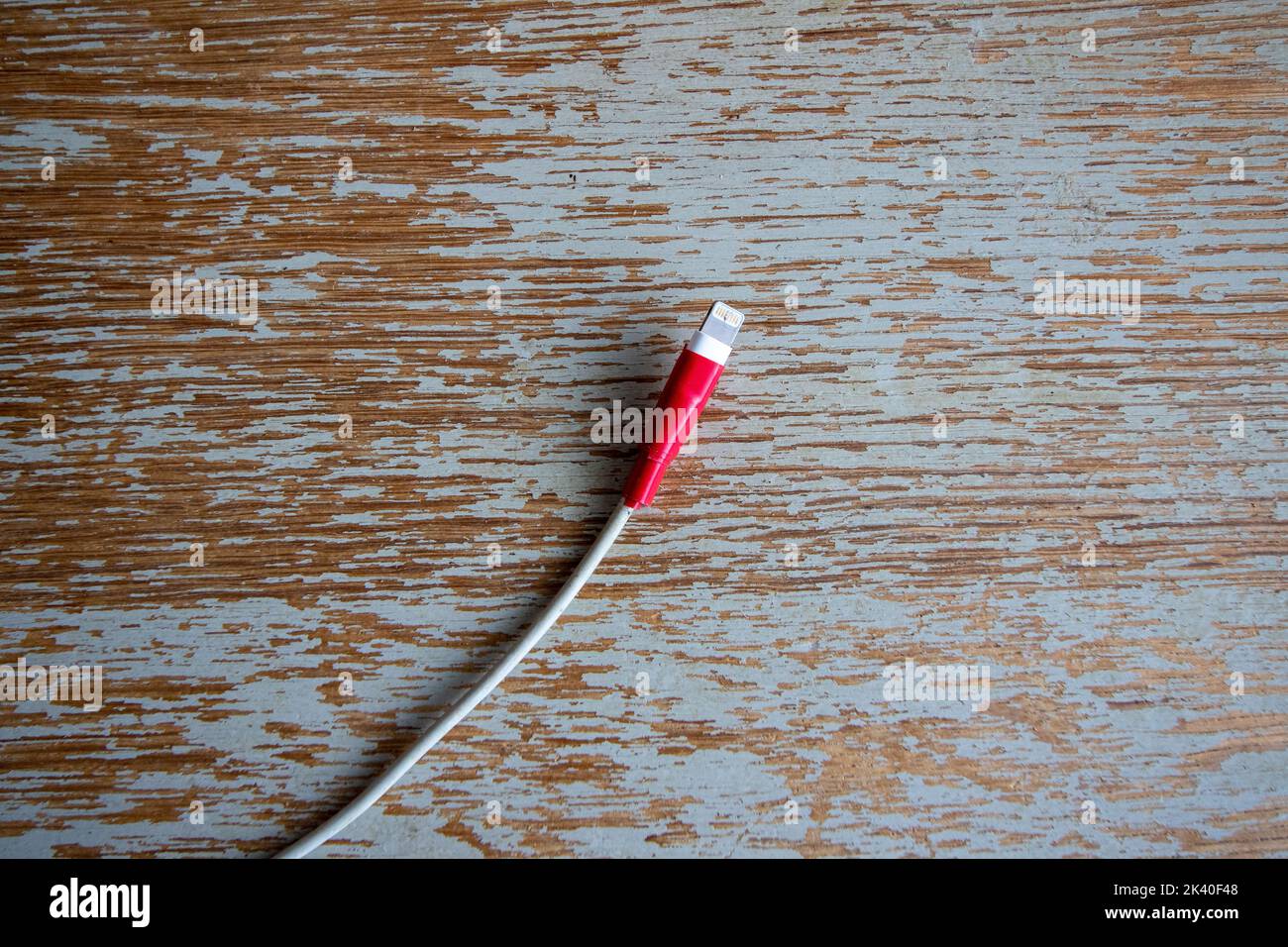 An Apple connector that has become unreliable repaired with sticky red ...