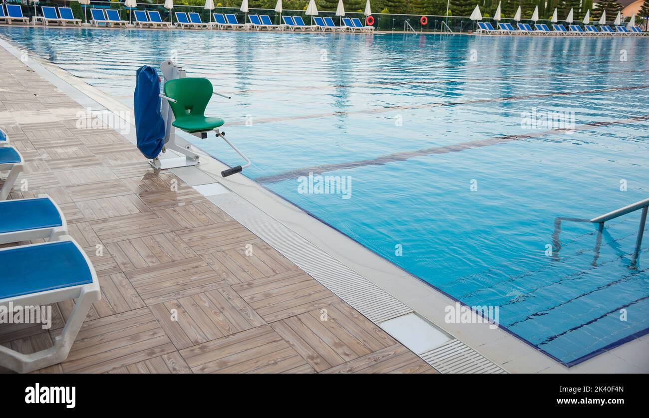 Swinging arm disabled chair. Swimming pool lift with a chair Stock ...