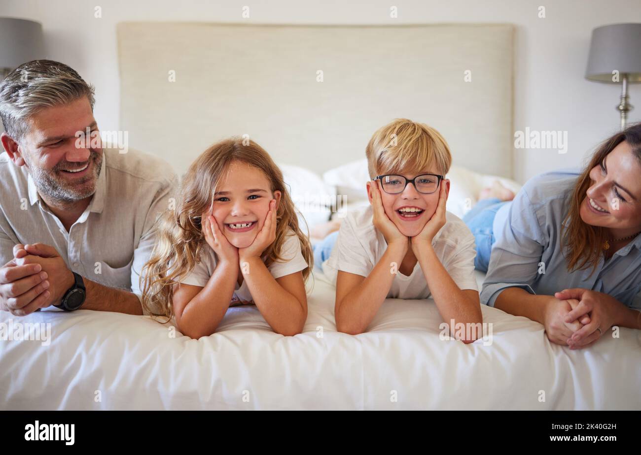 Relax, happy and love with family in bedroom together after wake up in ...