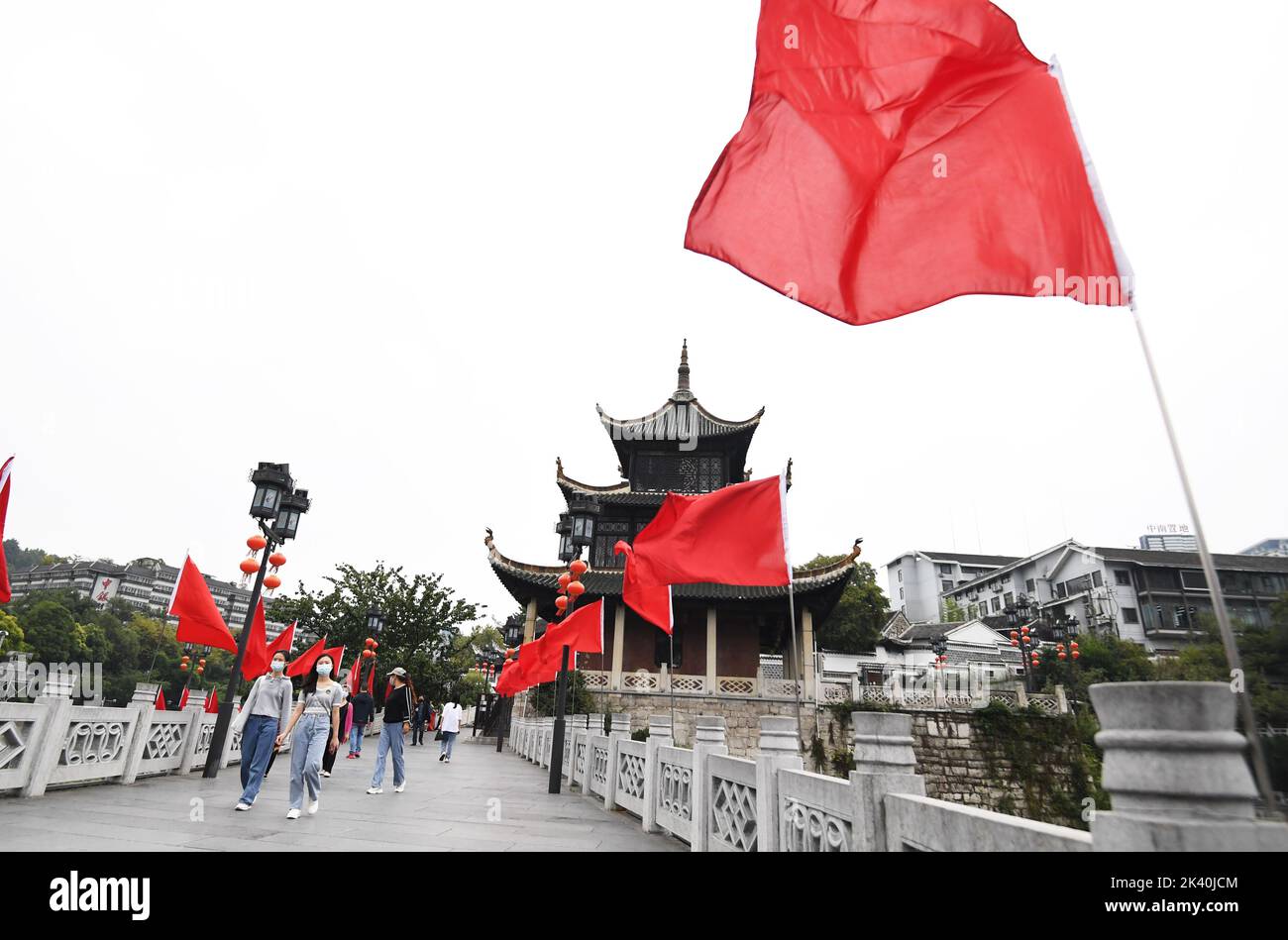 GUIYANG, CHINA - SEPTEMBER 29 2022 - Citizens walk along a street ...