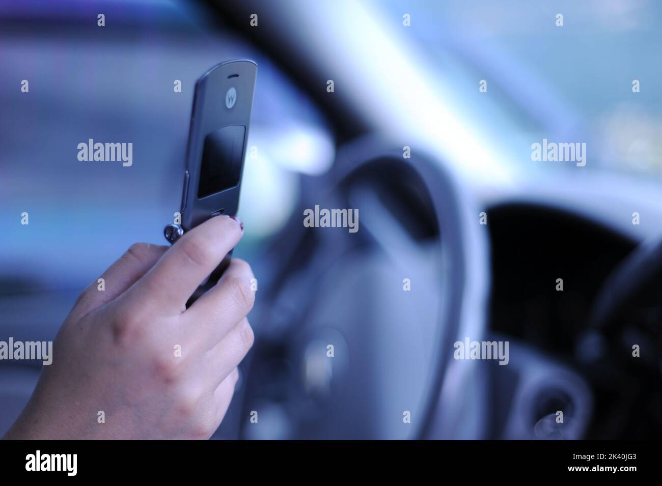 Transportation and vehicle concept - man using phone while driving the ...