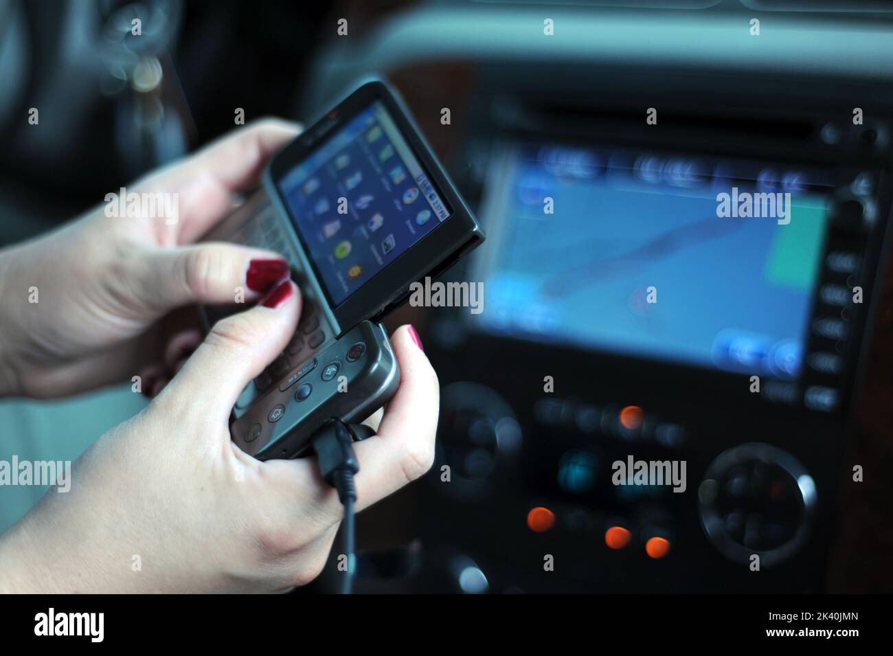 Transportation and vehicle concept - man using phone while driving the ...