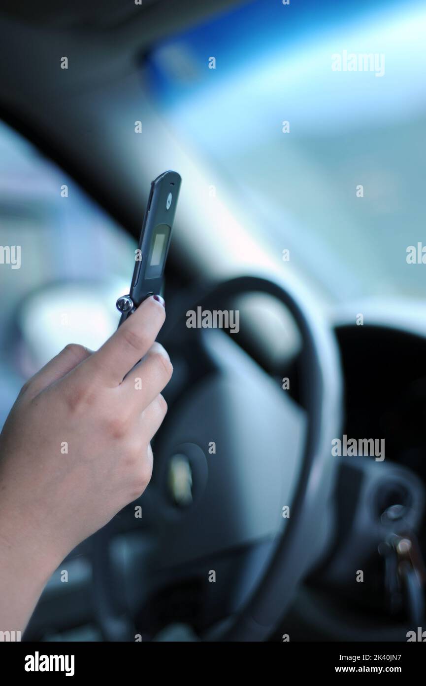Transportation and vehicle concept - man using phone while driving the ...