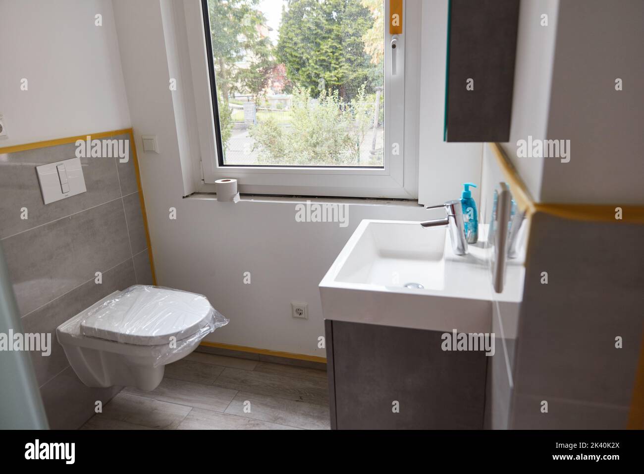 Mask edges for painting work in the bathroom or toilet when building a ...