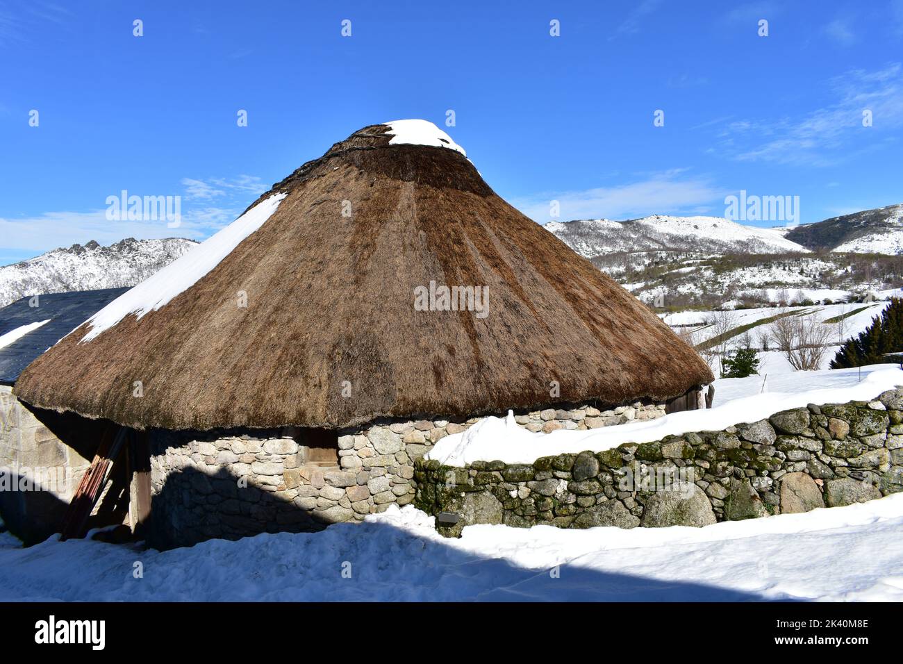 Ancient snowy palloza round house made with stone and straw. Piornedo ...