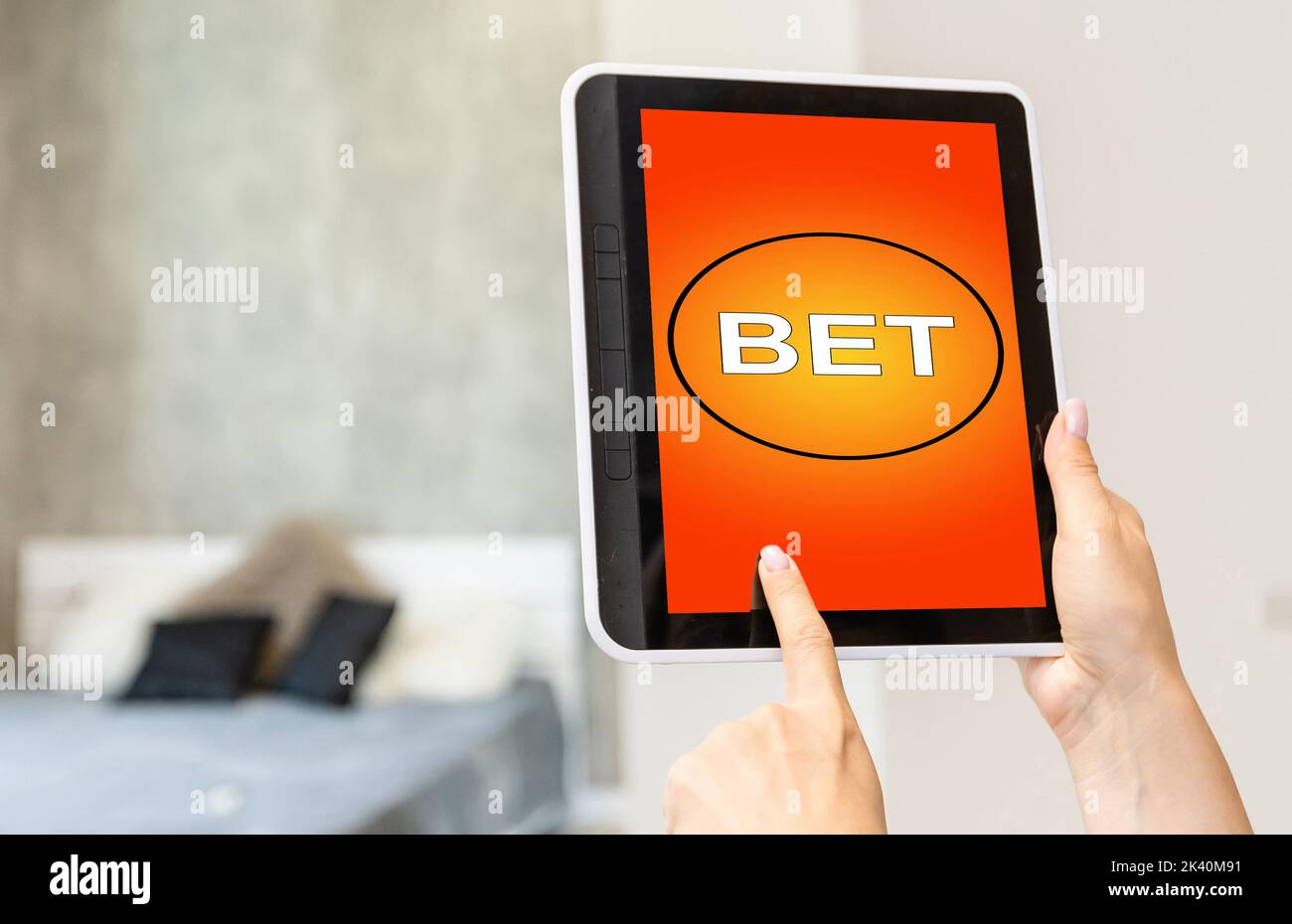 a woman makes bets on a tablet Stock Photo - Alamy