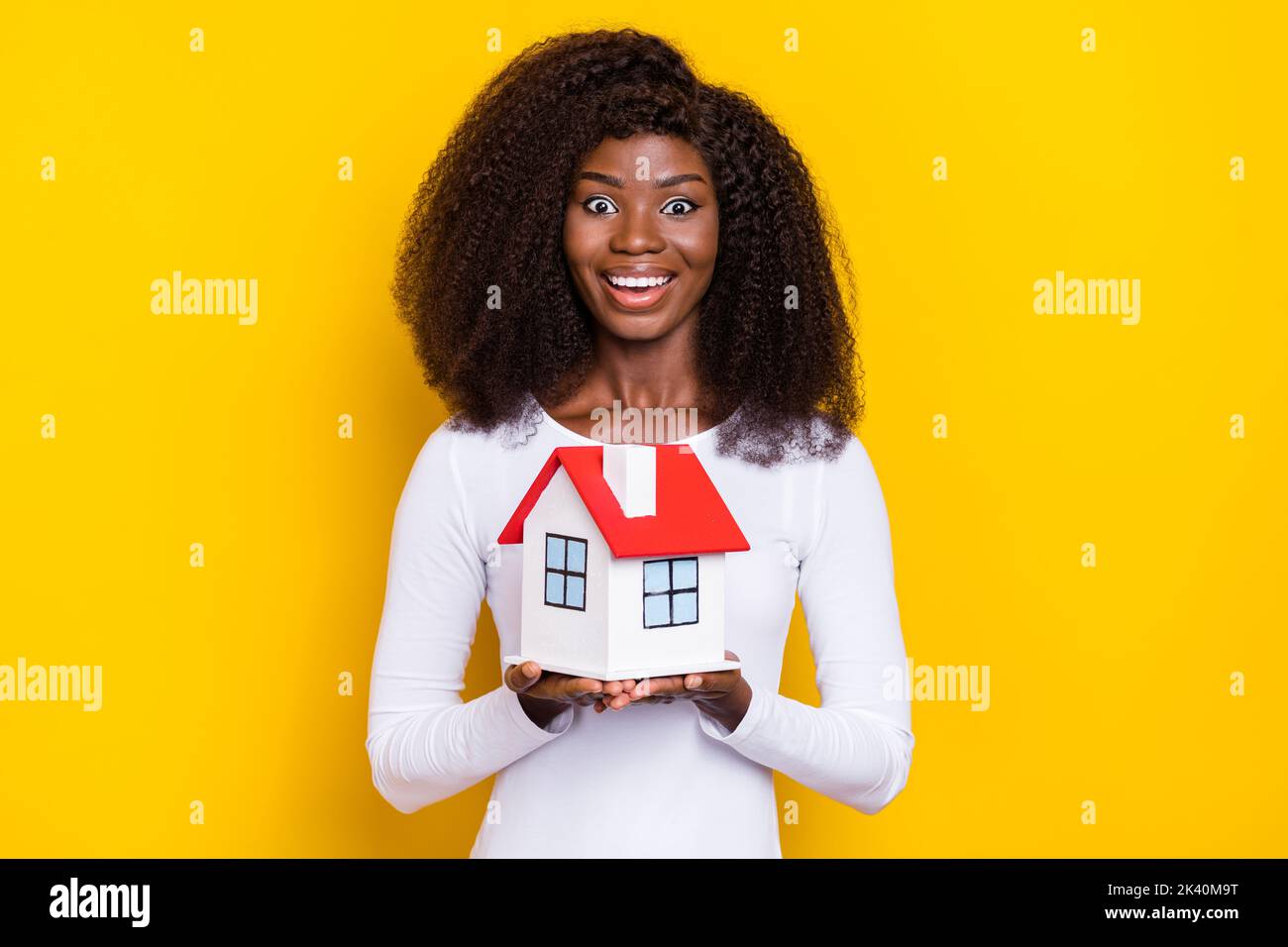 Photo of cheerful charming person arms hold small house toothy smile ...